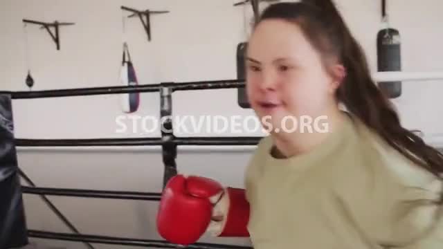 Woman with Down Syndrome boxing training, fitness, disability disabled