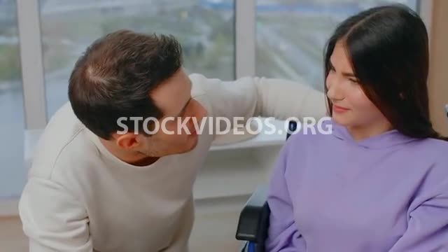 Attractive paraplegic woman in wheelchair talking to boyfriend, smiling ...